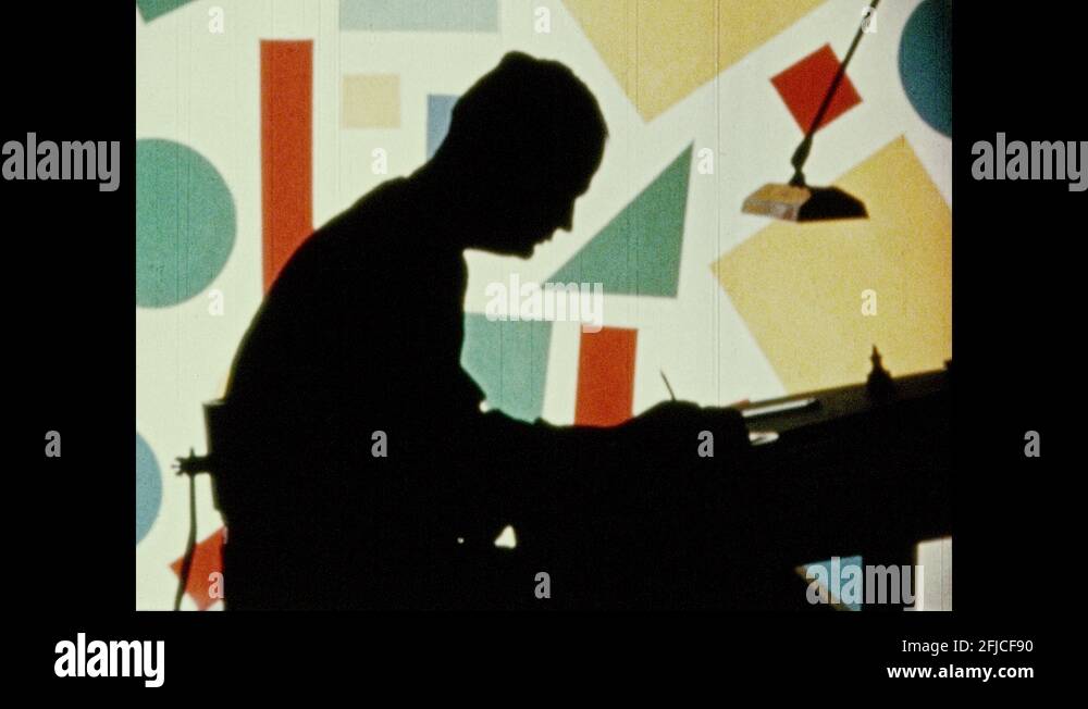 1950s: UNITED STATES: man works at desk. Artist creates drawings. Man ...