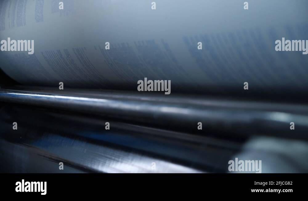 Specialist printer cleans the shaft of the printing press from the old ...