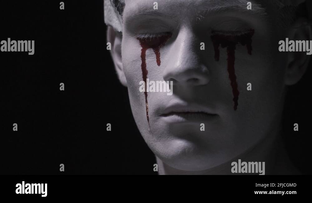 Scary marble statue with bloody tears, opens his eyes, close up Stock ...