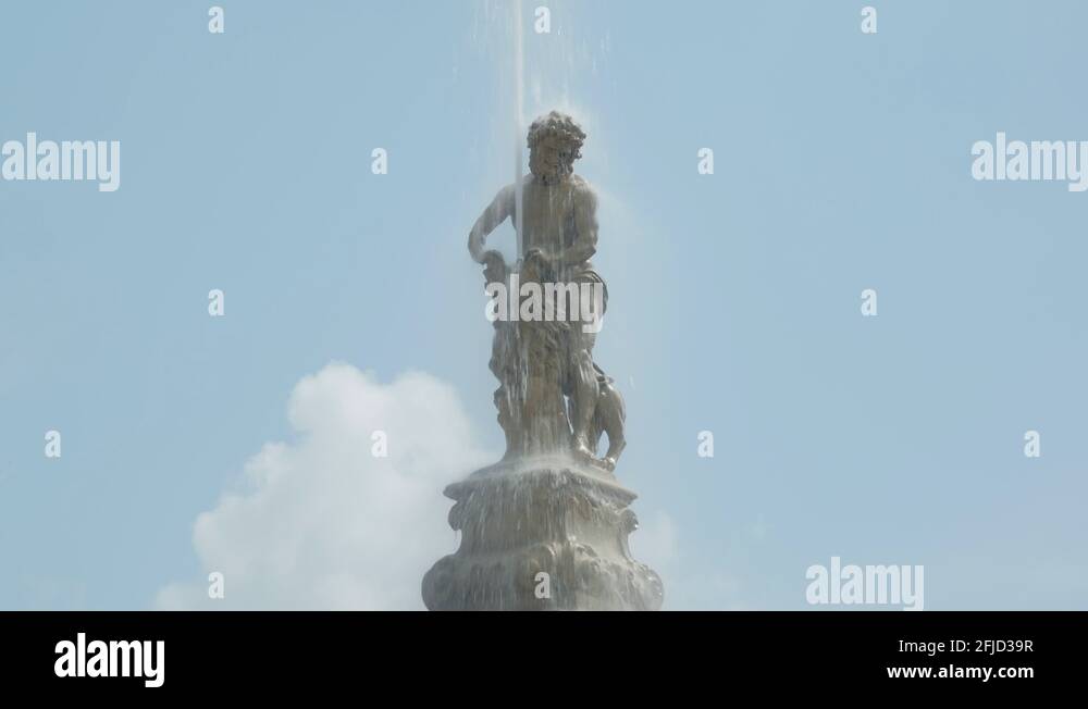 top part of old fountain with statue of human, water flows are ...