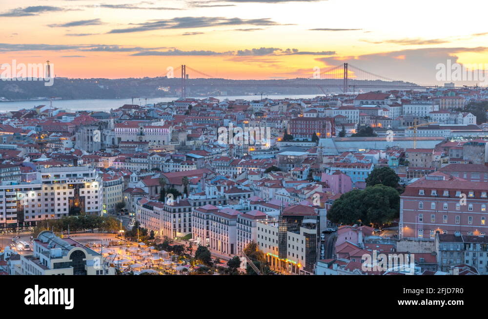 Lisbon after sunset aerial panorama view of city centre with red roofs ...