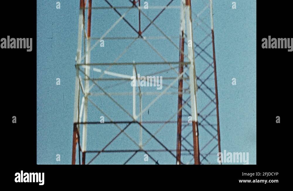 1960s: UNITED STATES: electricity tower. Tall building in city. School ...