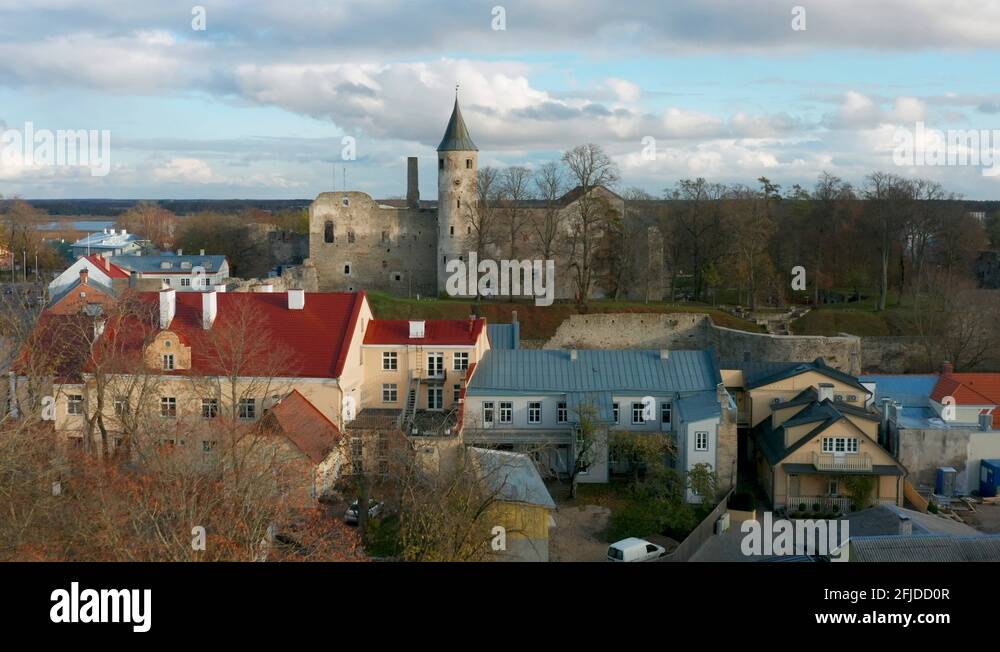 Close aerial flying past castle ruins in a small town Stock Video ...