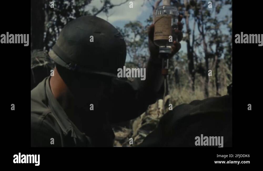 Aidmen treat wounded soldier and Soldiers pile dead soldiers into UH-1D ...