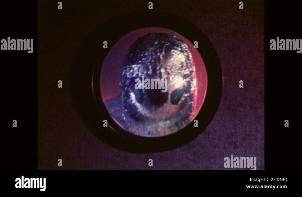 1980s: UNITED STATES: alien looks through window of space ship. Lights ...
