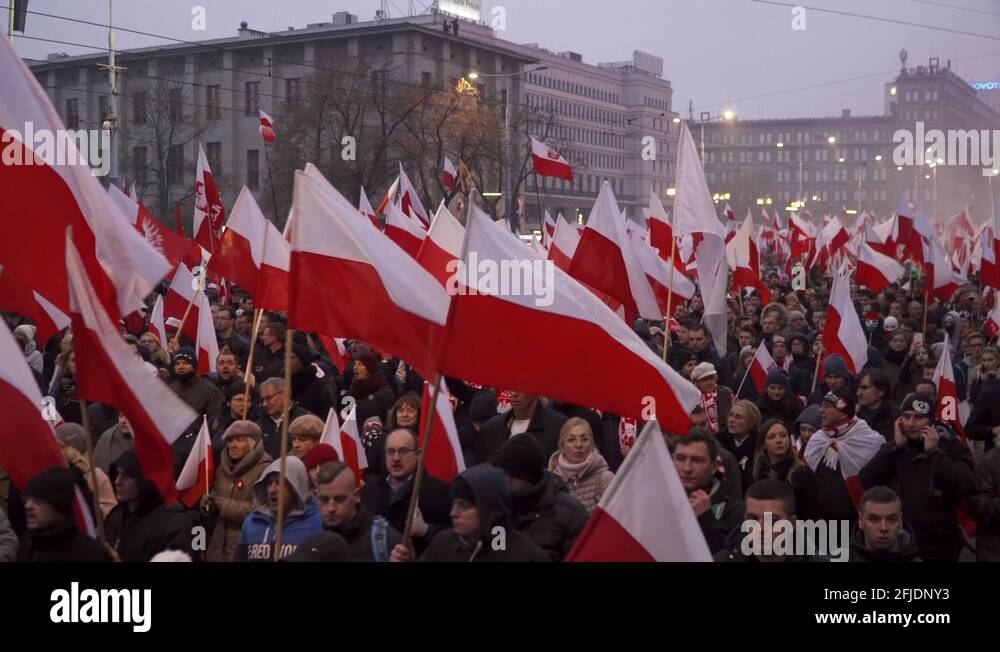 Polish citizens marching with flags waving on the 100th independence ...