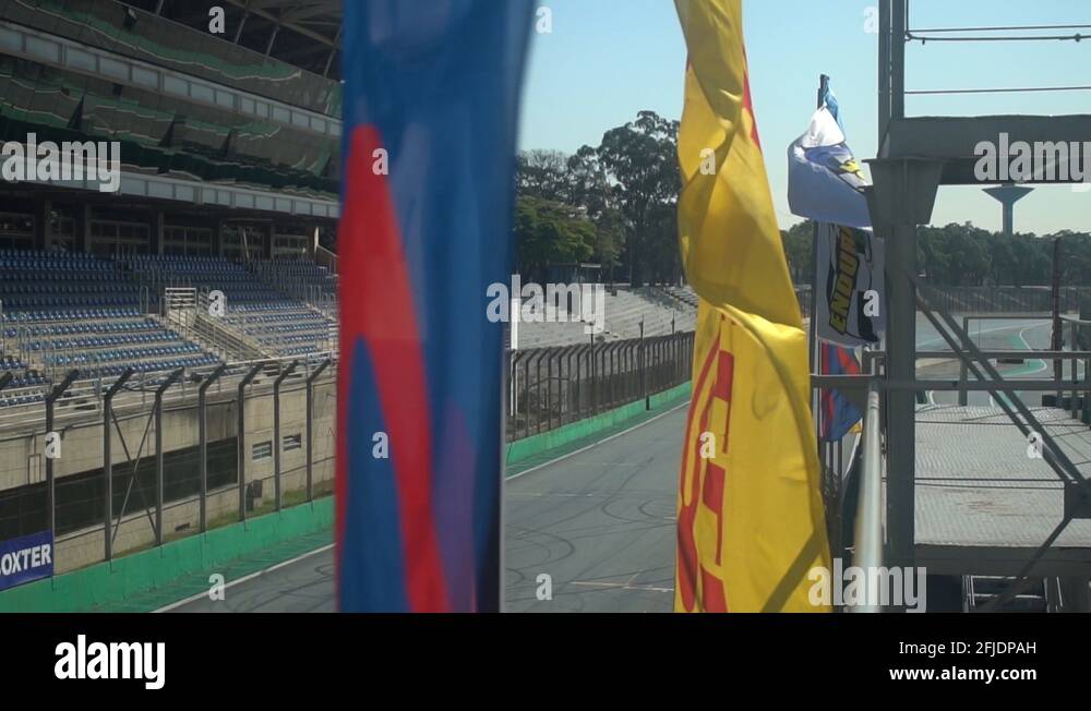 Sponsorship brand flags waving next to the crew marshal stand at the ...