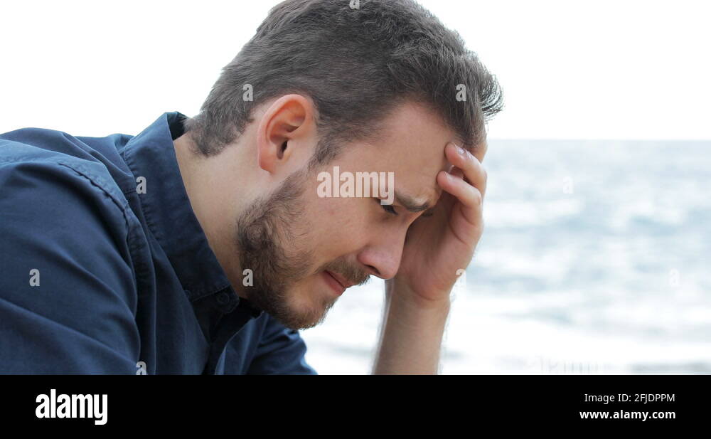 Sad man crying on the beach Stock Video Footage - Alamy