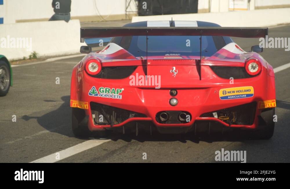 A Ferrari race car returns to the track after the pit stop during the ...