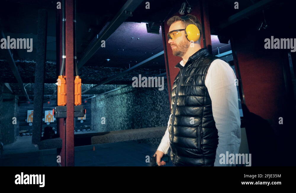 Person aims with a gun, standing in a pose, back view Stock Video ...