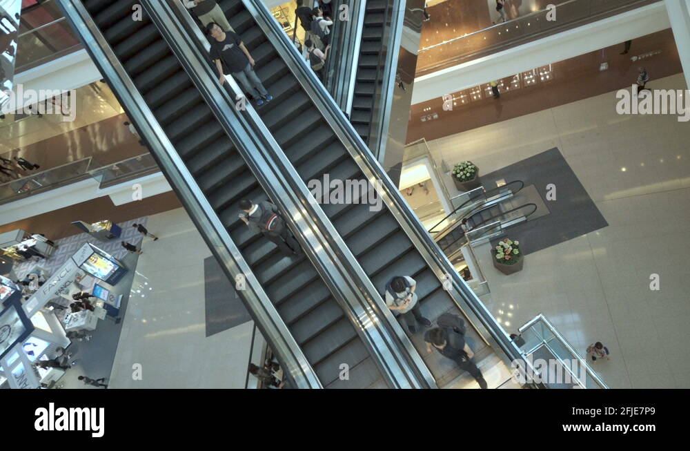 Customers clients moving on escalator staircases inside of giant shopping mall Stock Video ...