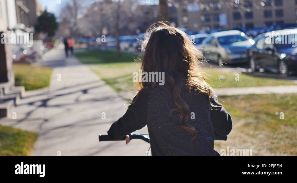 Angry little girl riding bike turns around and says something mean ...