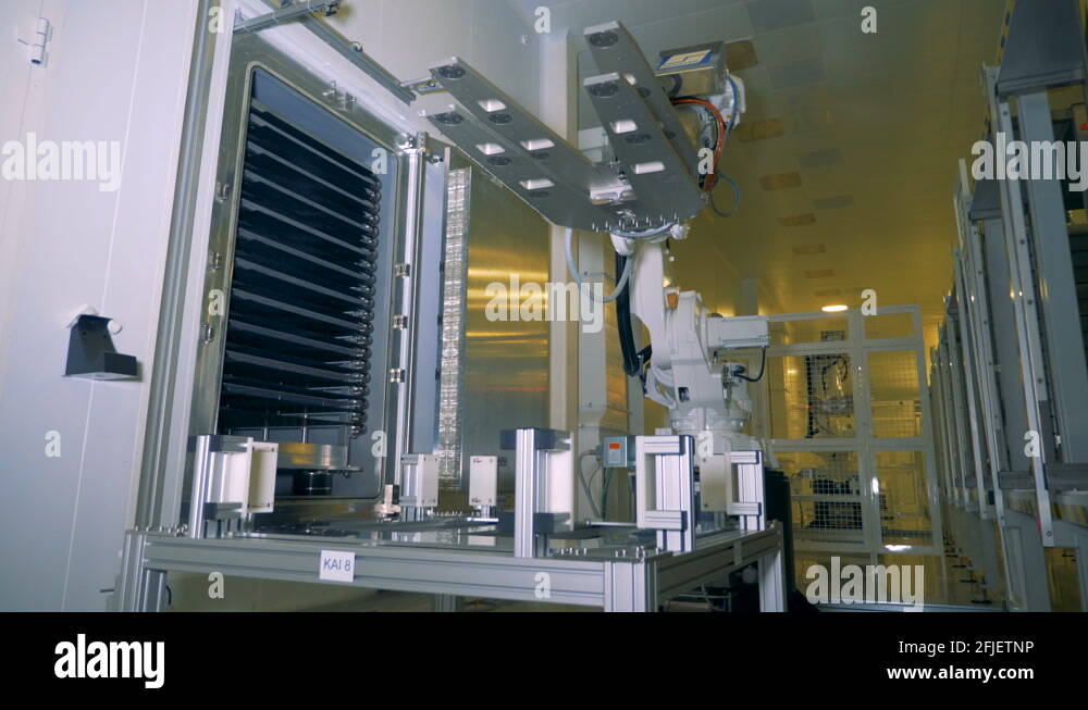 Factory equipment, robotic arm moving big solar panels, close up Stock ...