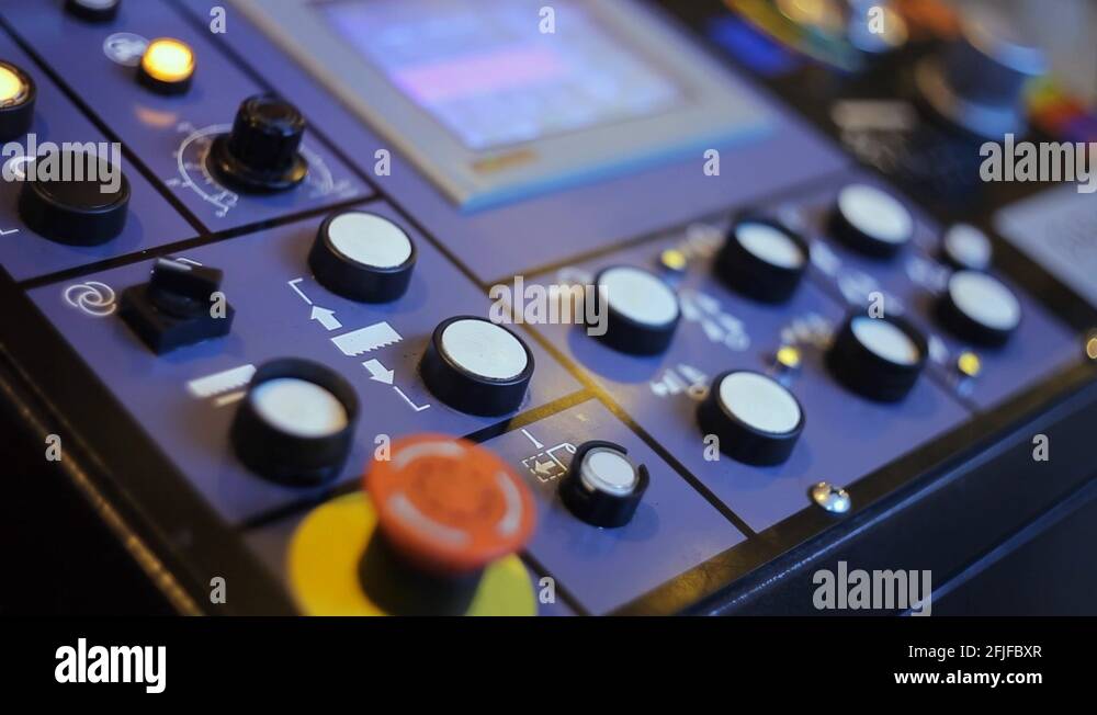 Engineer controlling automated production line on control panel with ...