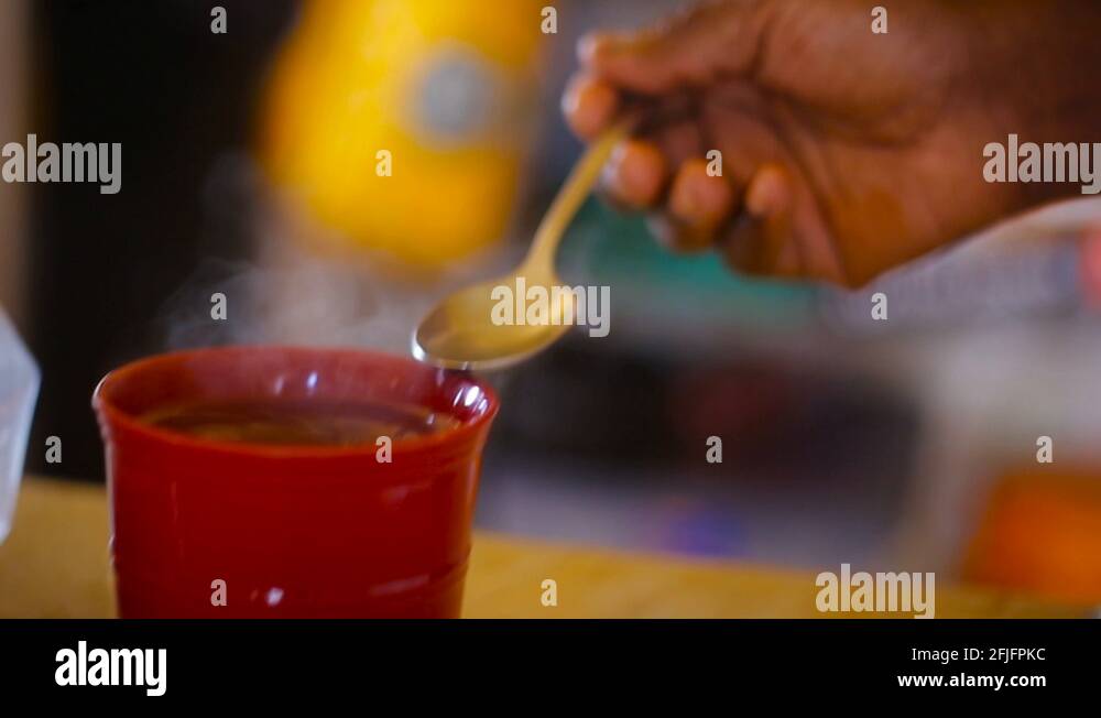 father taking a sip of the hot tea after which he realized it was too ...
