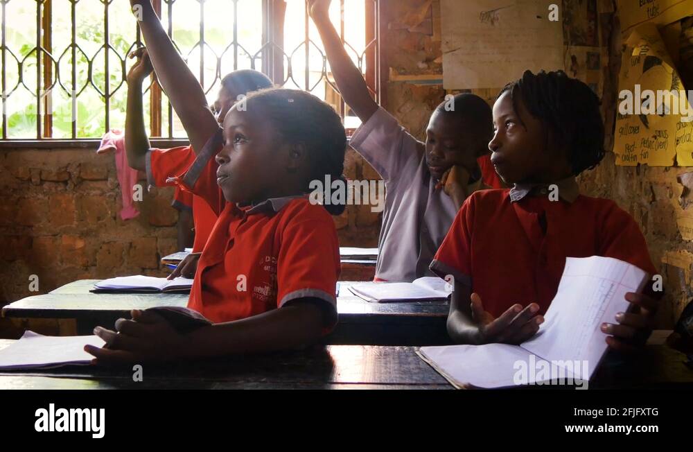 african kids raise their hand during class to give the right answer ...