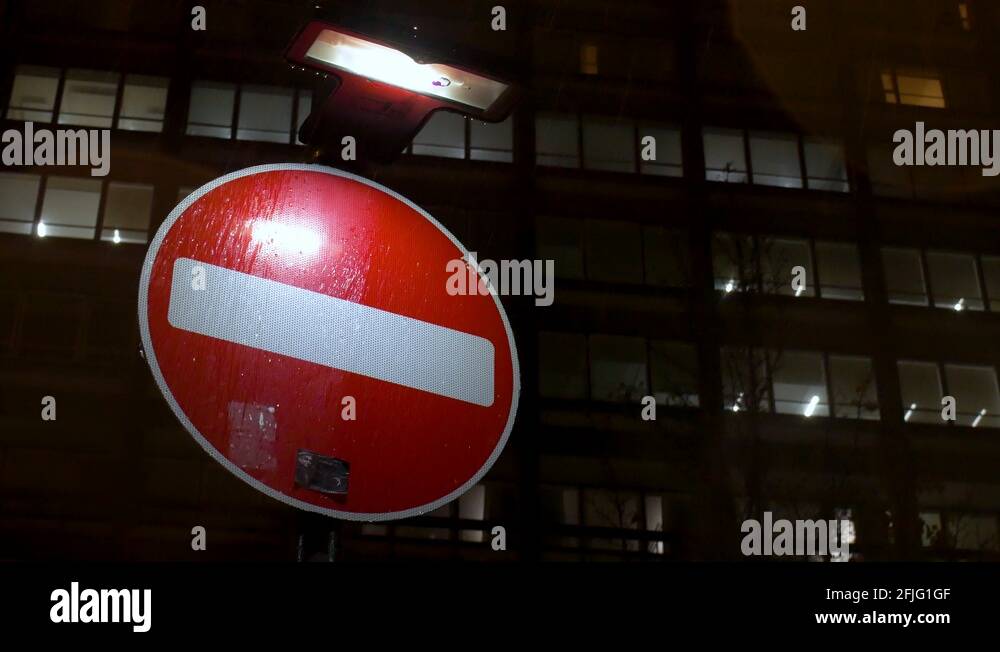 No entry traffic sign during rainy night. Raindrops fall on lens, can ...
