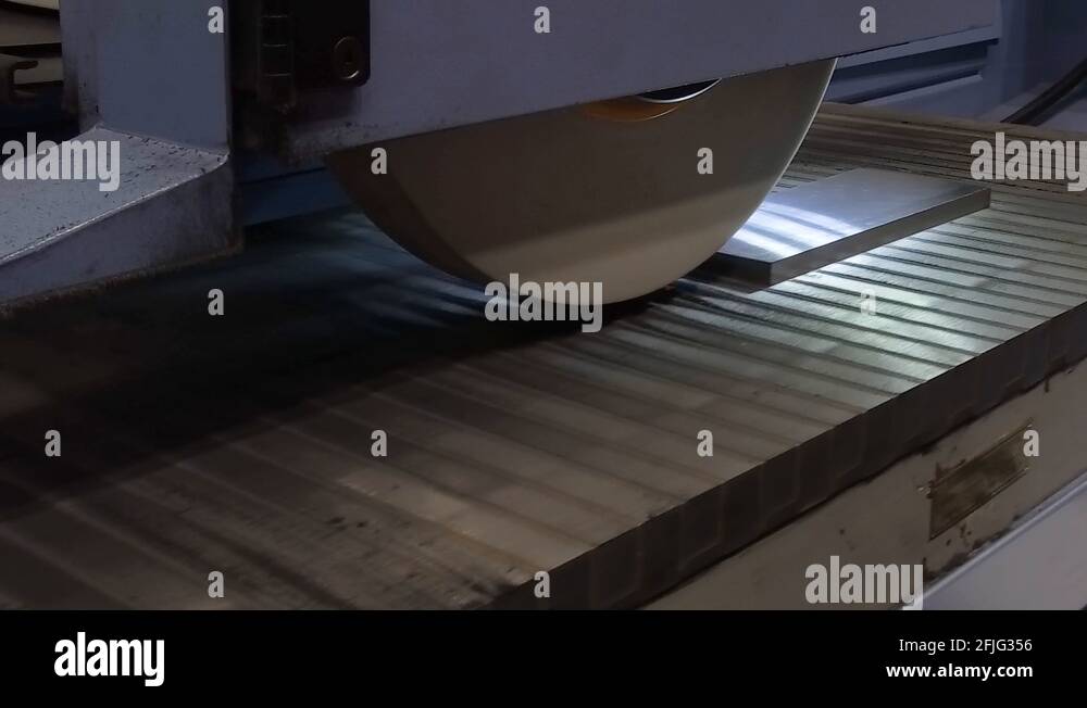 Work of an industrial surface grinding machine. Grinding of a flat ...