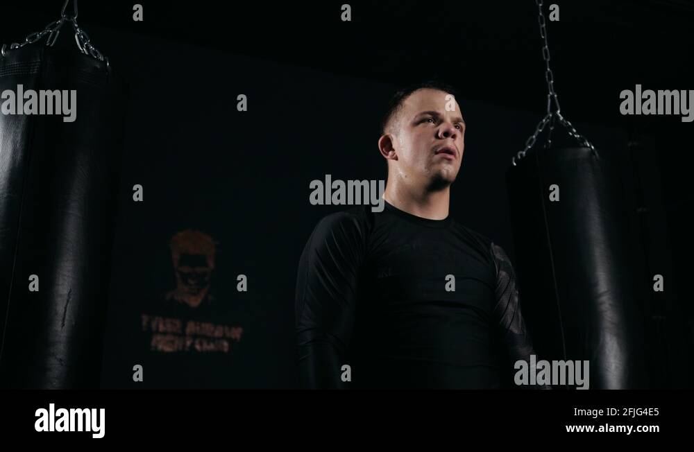 Portrait man in boxing pose stand. Young Boxer fighter over black ...