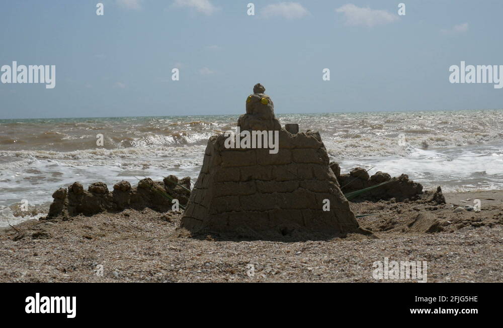Sand Castle on beach background of sea waves Stock Video Footage - Alamy