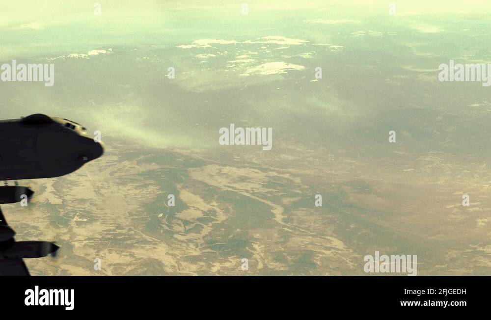 Lockheed C-130 Hercules military transport aircraft flying from left to ...