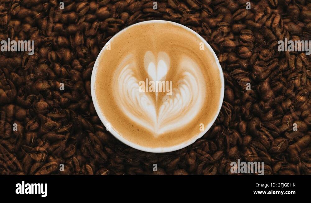 Cinemagraph of latte in coffee beans background Stock Video Footage - Alamy