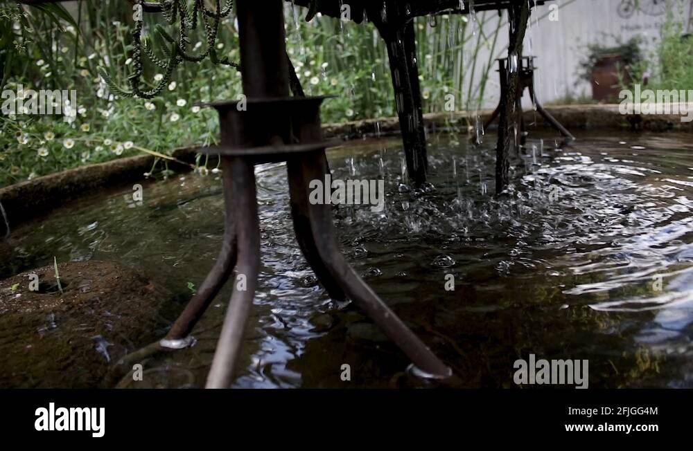 Medium pan right of water dripping off of water feature Stock Video ...