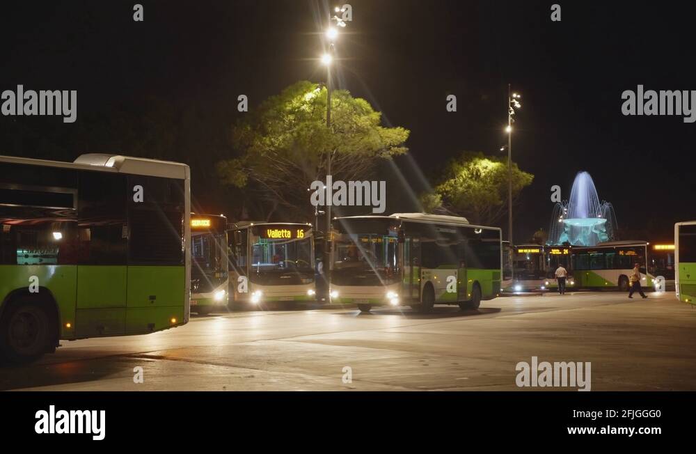 Bus terminal in Valletta, Malta. Bus arrives to terminal by night. Main ...