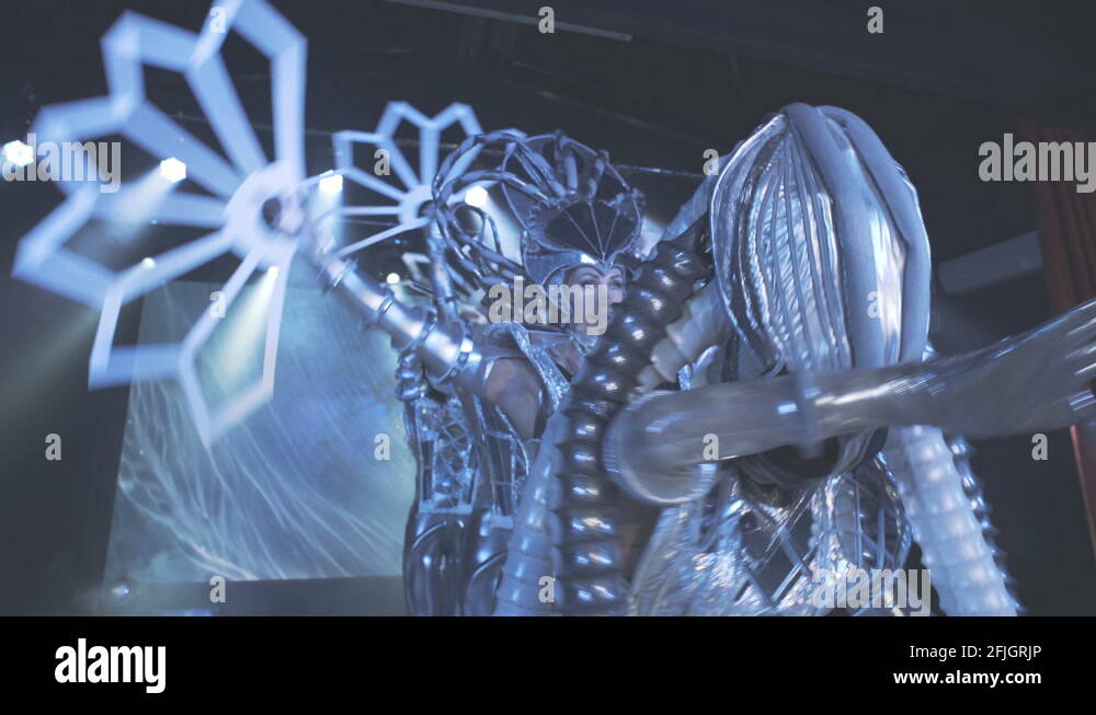 Beautiful girls in brilliant costumes of aliens perform on stage ...