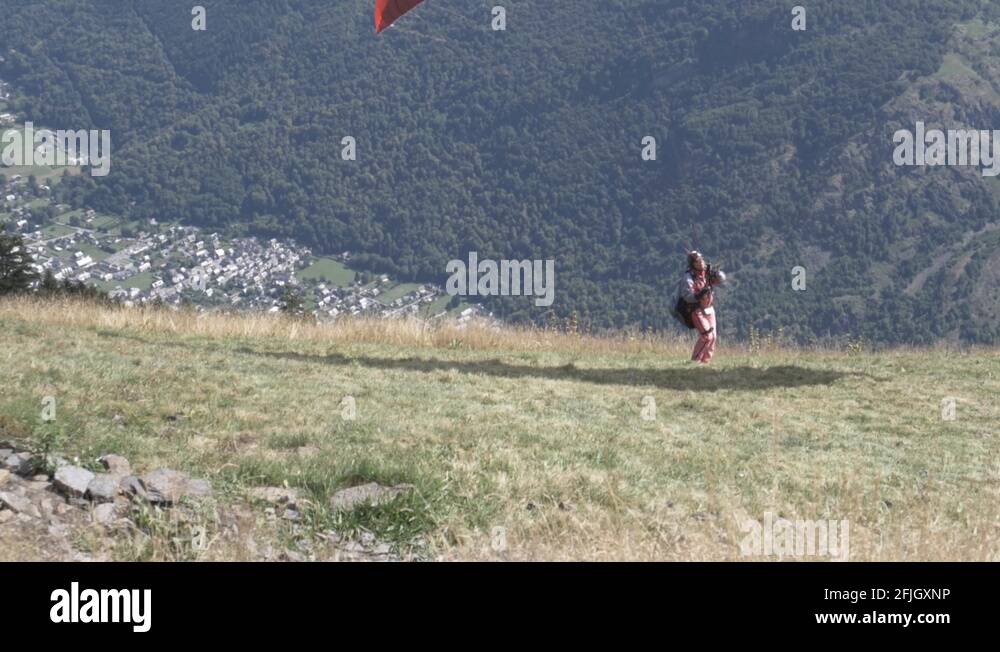 people skydiving off a mountain in france Stock Video Footage - Alamy