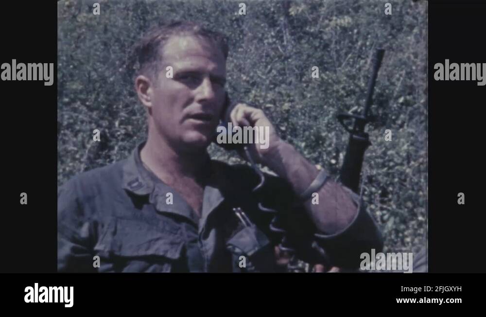 American soldier talking over telephone and soldiers in bushes - 1970 ...