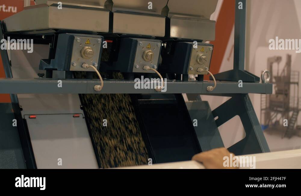 Automatic Industrial grain sifter. Grains are screened by robot ...