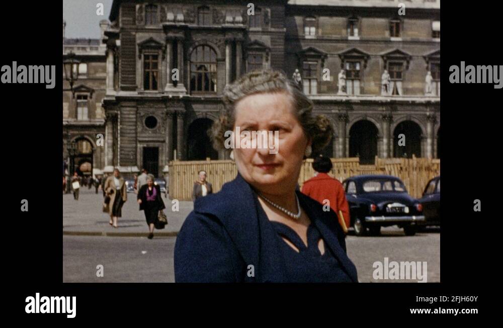 1940s: Woman poses outside of Louvre Museum in Paris, France Stock ...