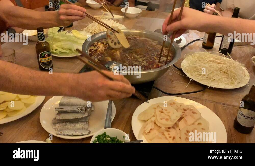 Close up shots of people without faces cooking food on the table using ...
