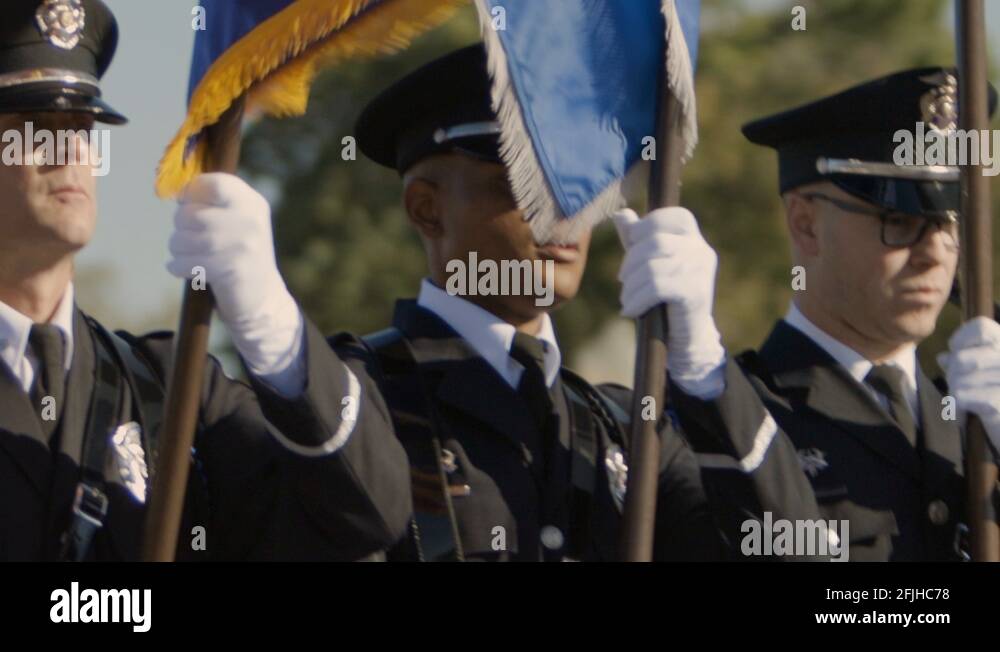Police marching in a parade with flags Stock Video Footage - Alamy