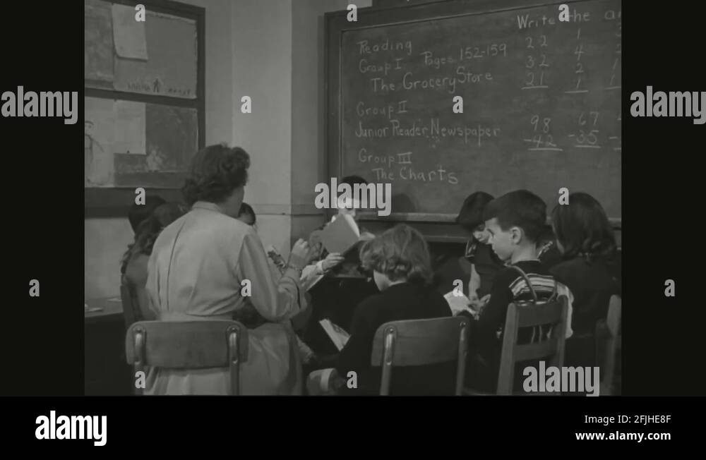 Teacher teach preschool kids on blackboard in class at Elementary ...