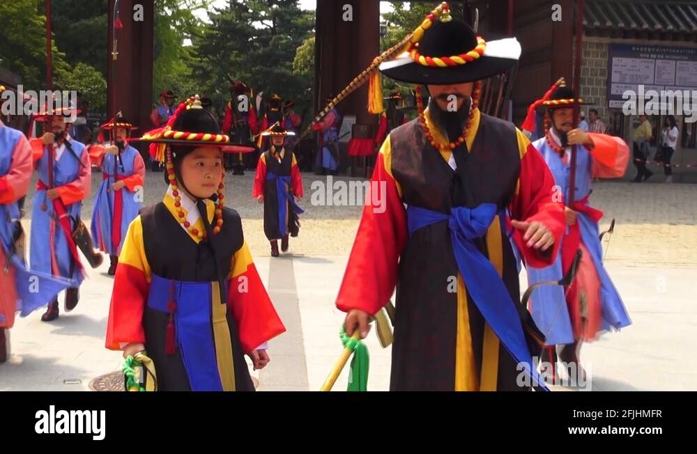Old bearded korean man and child in traditional korean clothes posing ...