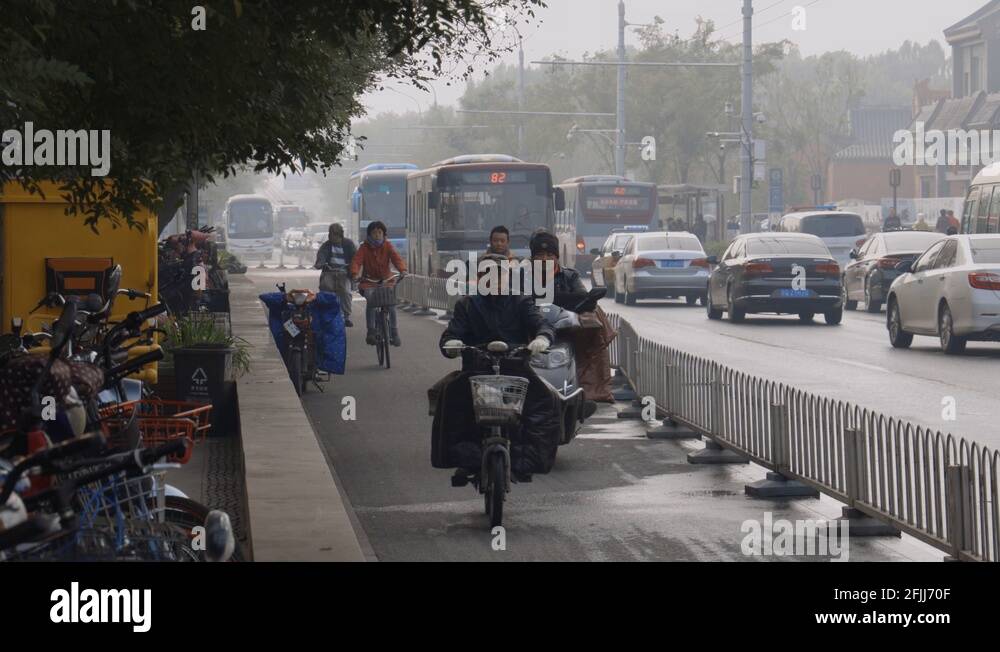 Bustling Beijing public city street with locals and multiple modes of ...