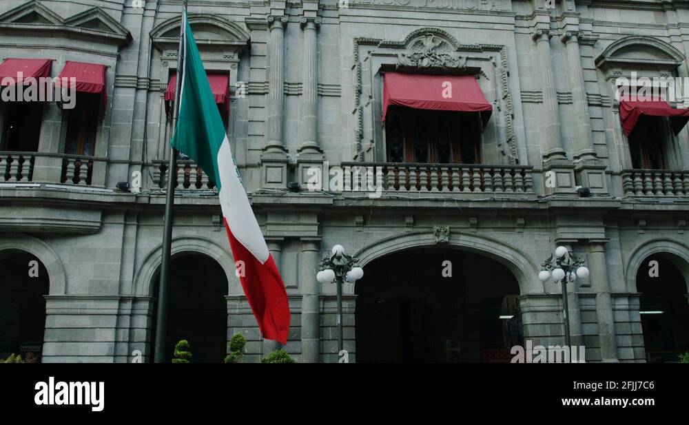 Mexican architecture and flag in slow motion at Zocalo de Puebla area ...