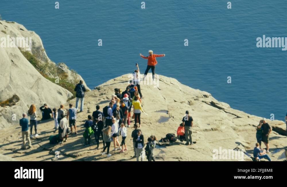 Hero pose atop of Pulpit Rock, zoom pull, people posing on the edge of ...