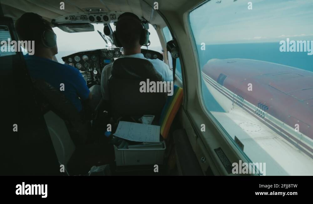Behind the Cockpit of a Small Piper Turboprop Airplane. Two Male Pilots ...