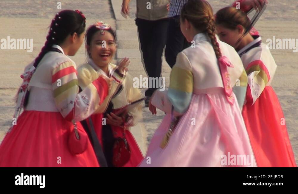 Four women in traditional hanbok korean outfit talking in Gyeongbokgung ...