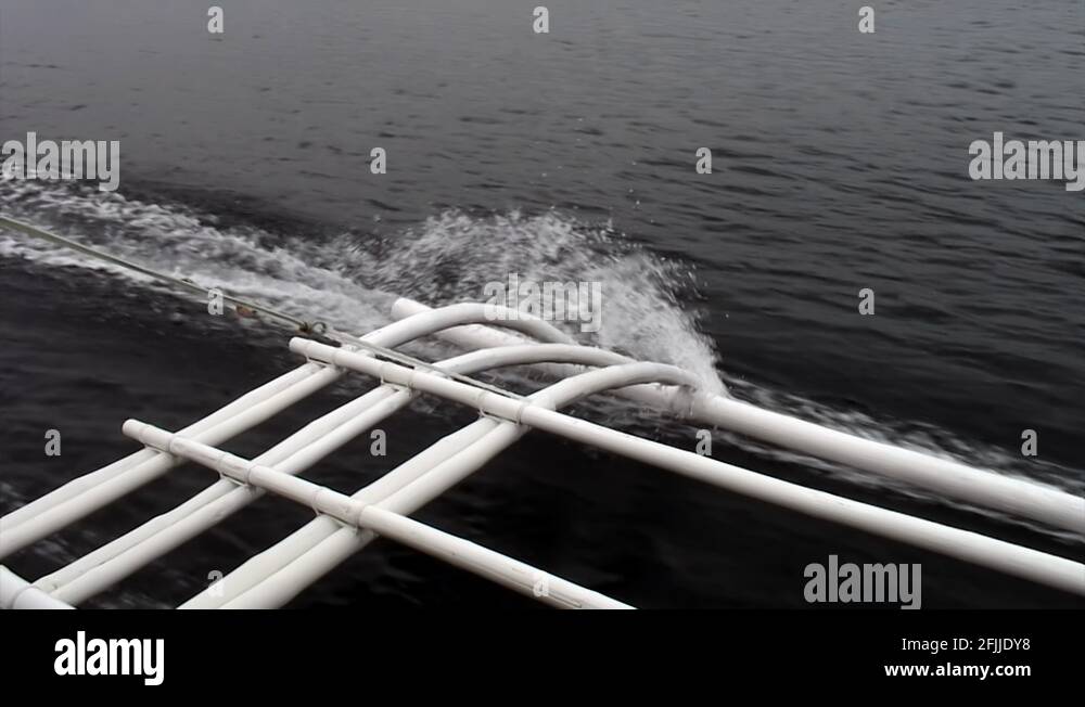 Bamboo wings of moving philippine boat in sea on islands of Philippines ...