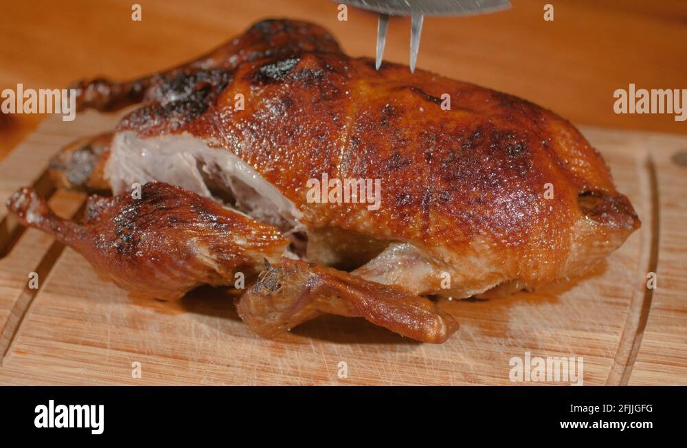 Crispy-Skinned Roast Young Duck Is Slicing Along Breast With Sharp ...