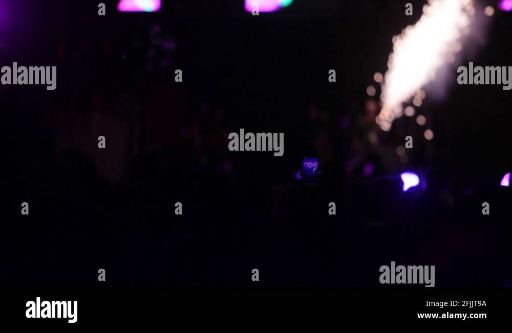 Crowd of people dancing, clapping hands and enjoying a concert with ...