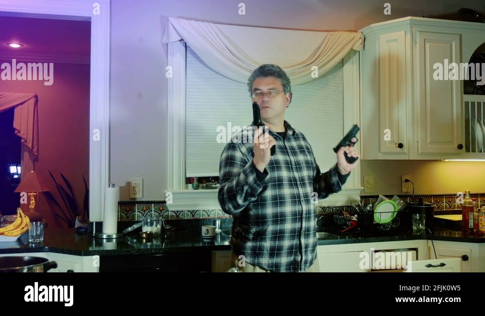 paranoid man with guns looking around Stock Video Footage - Alamy
