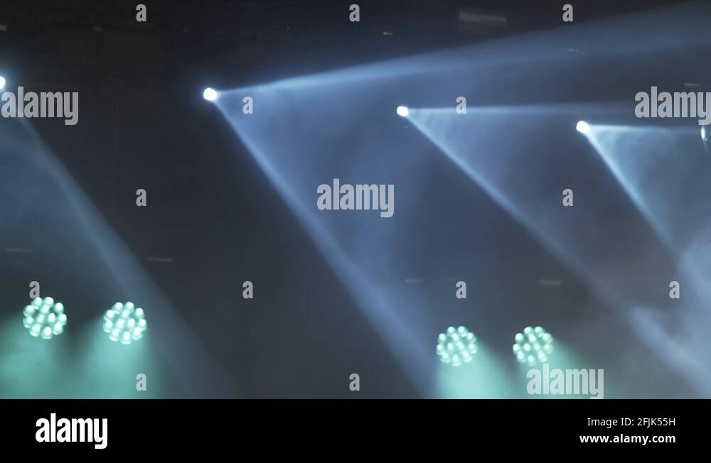 Stage lights are turned on during the concert blinking and shining ...