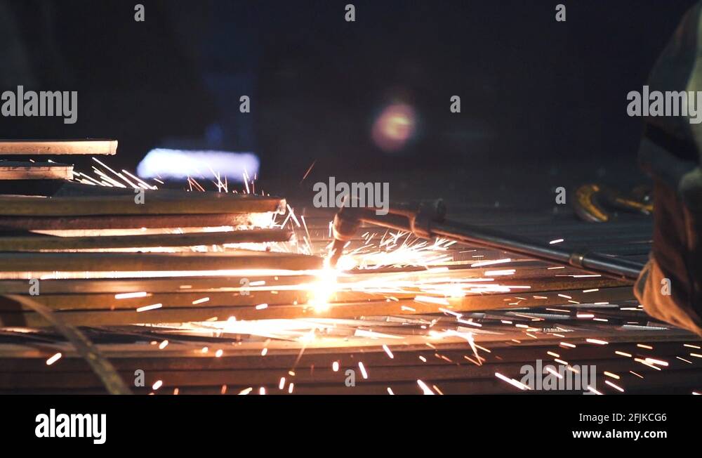 sparks from metal cutting. Industrial worker cutting steel by using gas ...
