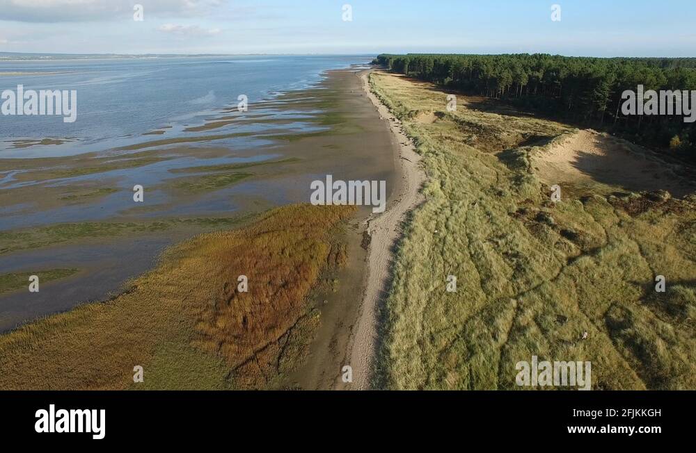 Drone footage of Scottish river estuary, beach, sandbanks and forest ...