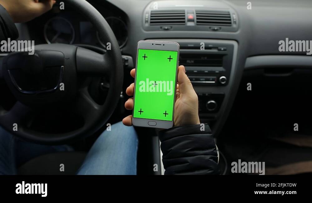 Man holding empty green screen of smartphone in car, chroma key Stock ...